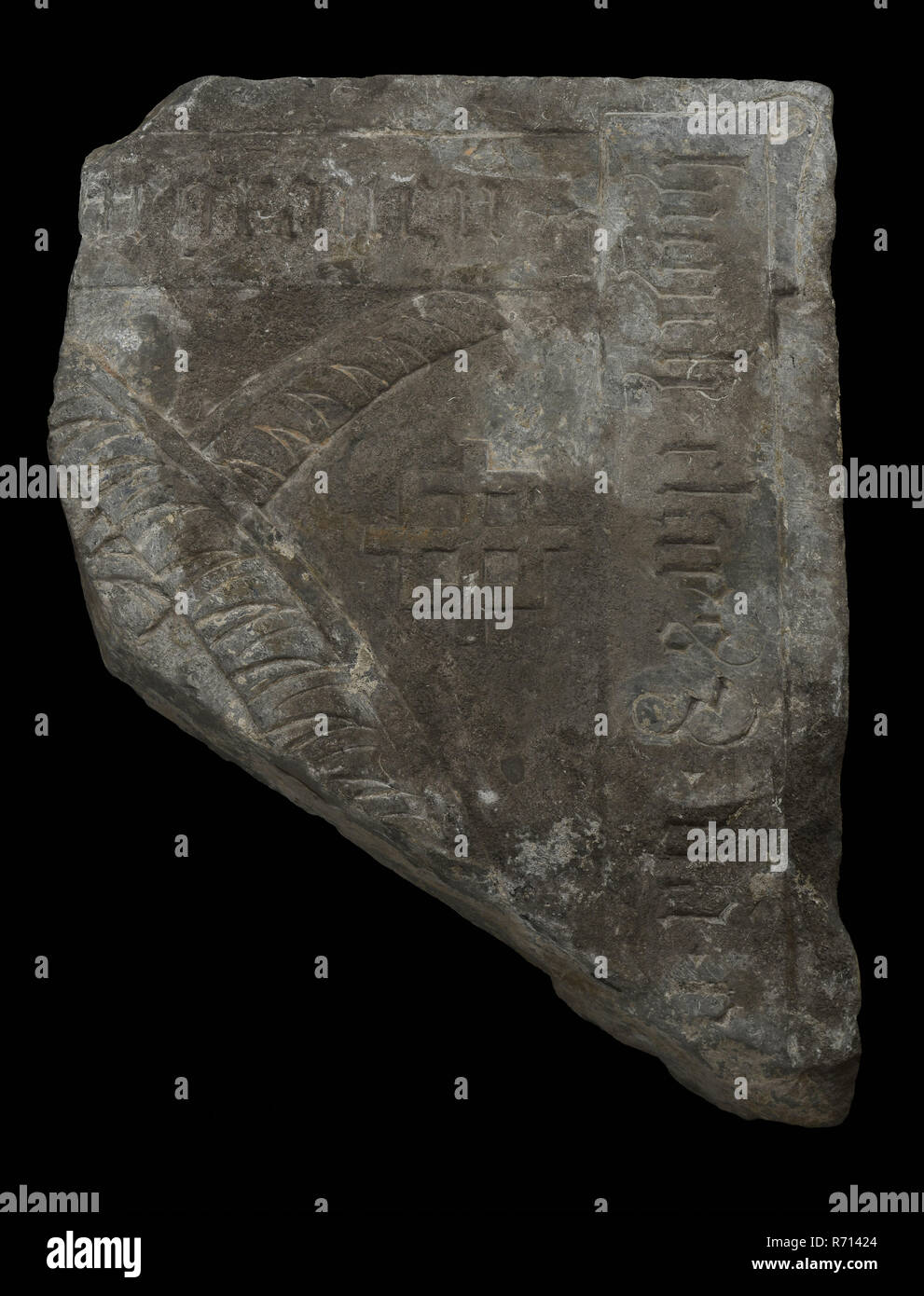 Fragment tombstone with text Gothic letters and two crossed feathers ...