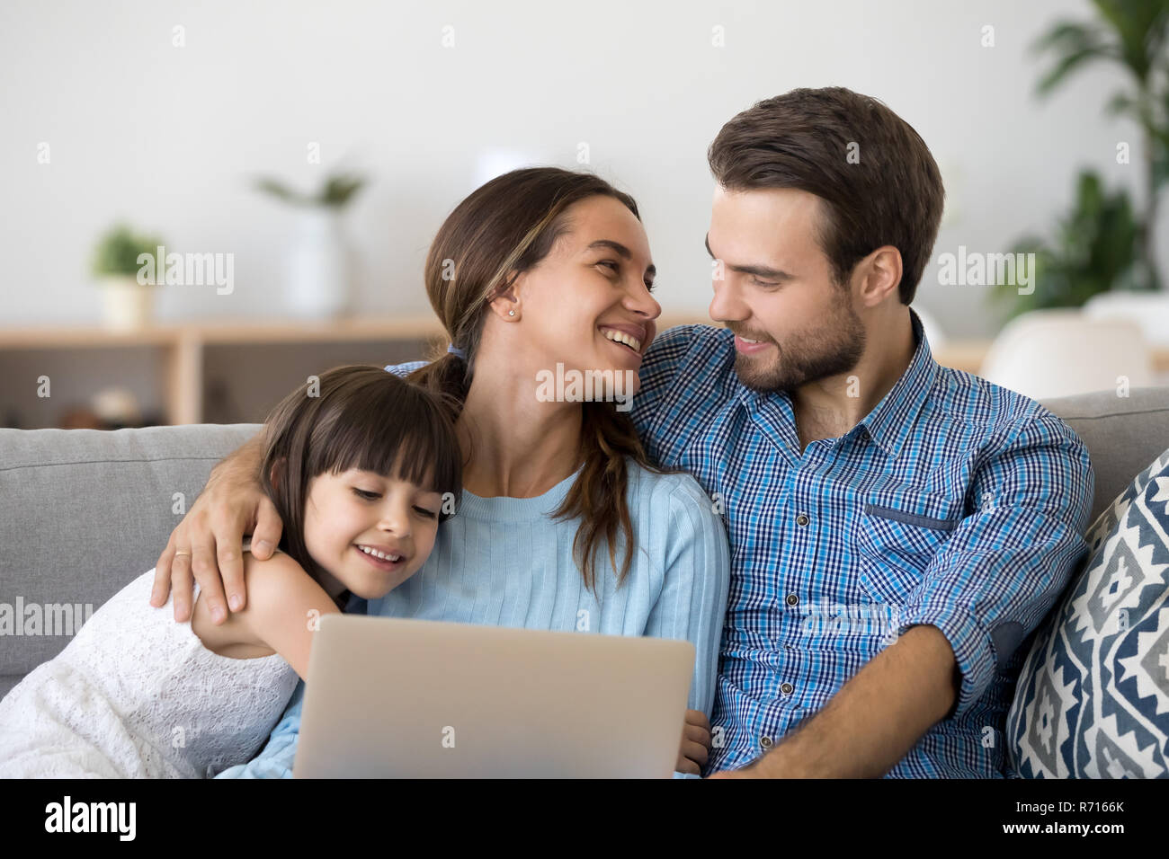 Diverse family spend free time at home using laptop Stock Photo - Alamy