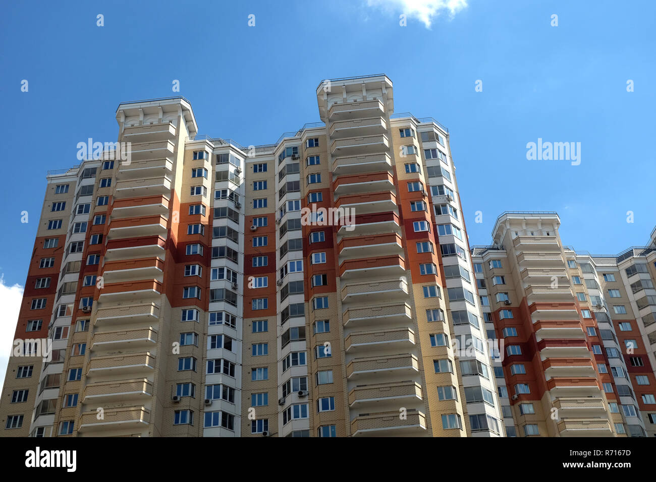 Top section of modern apartment building constructed from bricks over ...