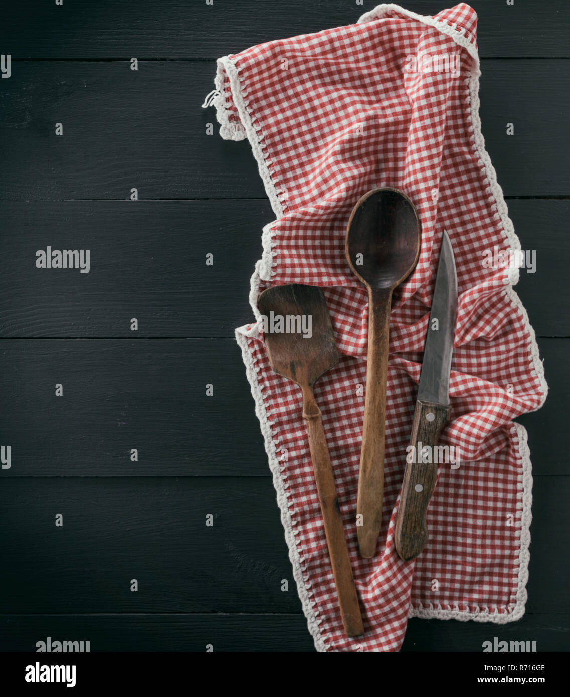 old wooden spoon, scapula and knife on a textile red towel Stock Photo ...