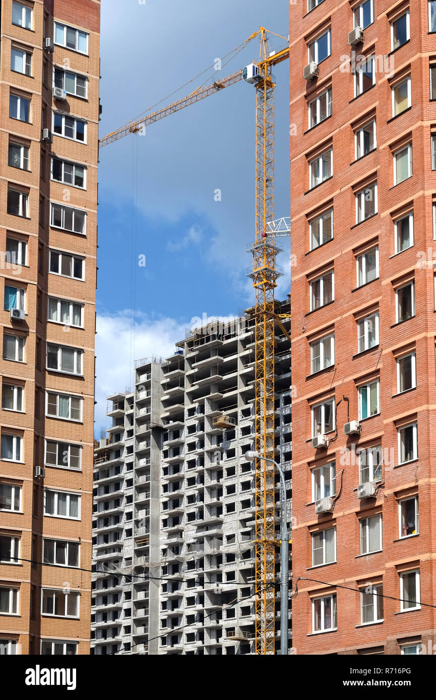 Urban scene. Construction of city district. Constructed brick houses in ...