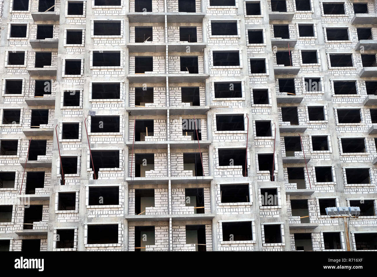 Front view of high-rise modern apartment building construction in ...