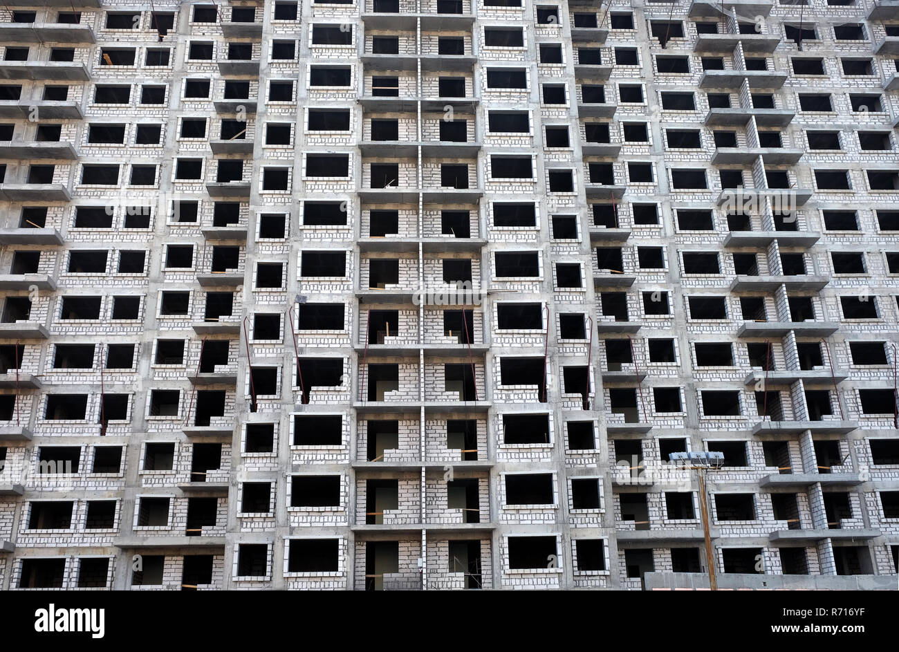 Front view of high-rise modern apartment building construction in ...