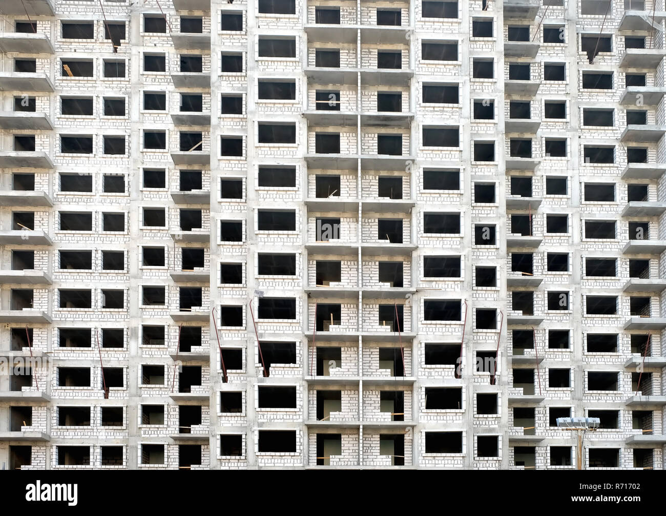 Front view of high-rise modern apartment building construction in ...