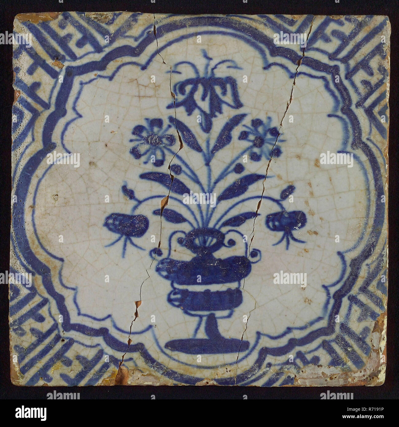 Tile with blue pot with flowers in braid-shaped frame; corner pattern ...