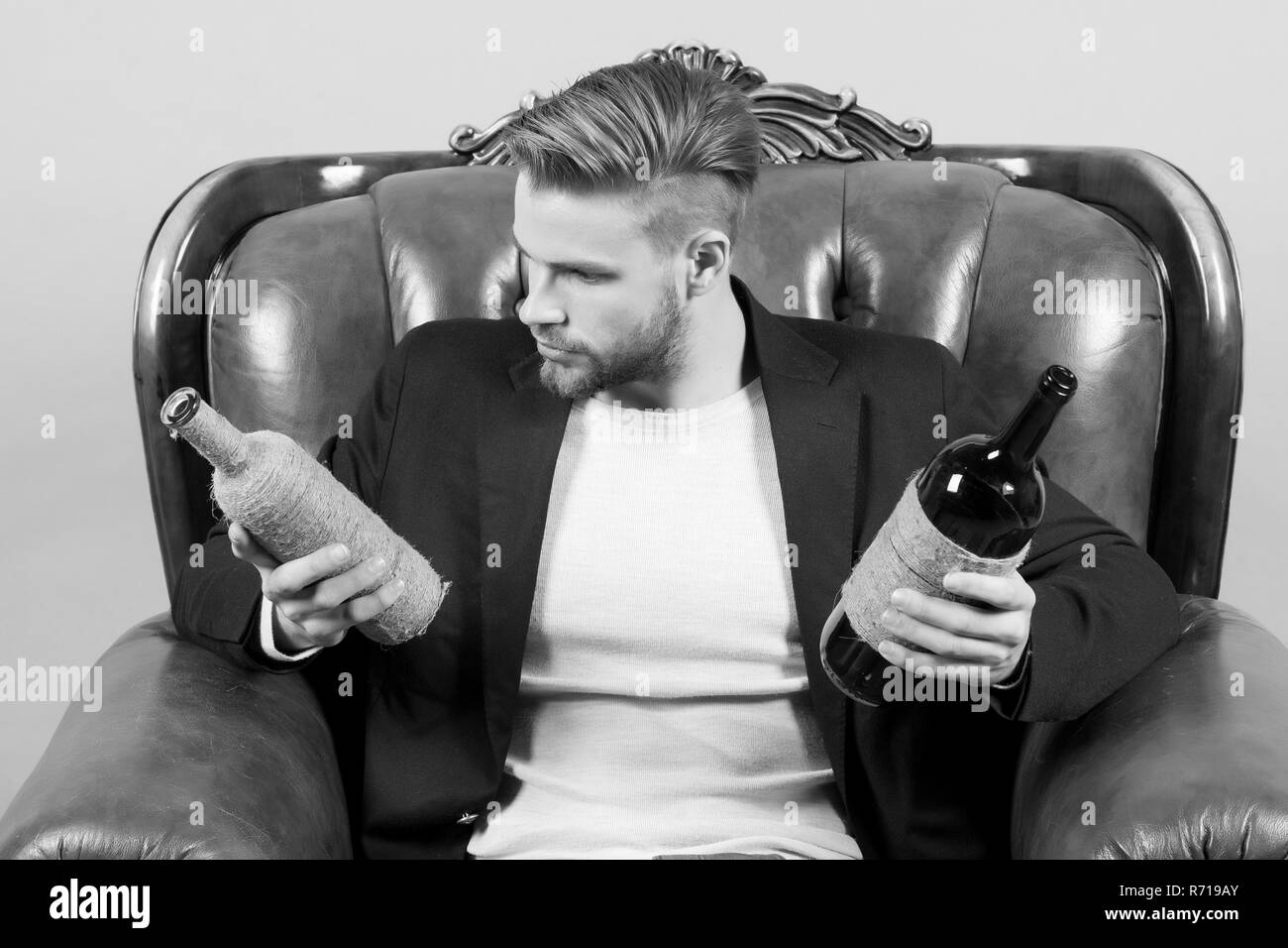 Alcohol addiction, bad habits. Man choose wine to drink. Guy with ...