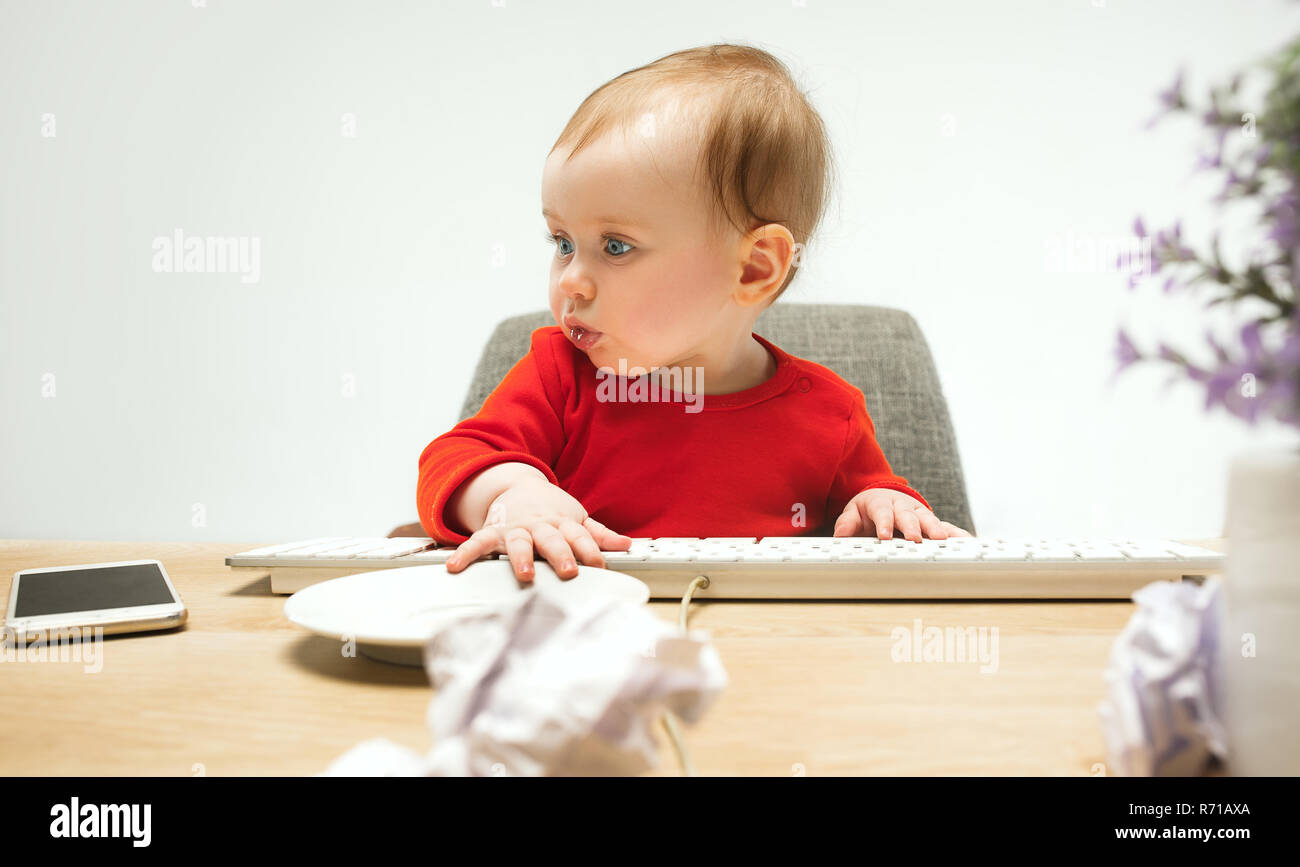 Happy child baby girl toddler sitting with keyboard of computer ...
