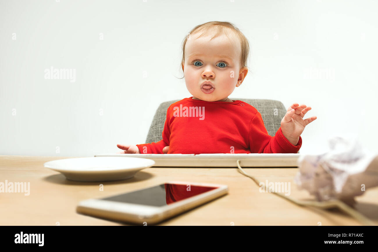 Happy child baby girl toddler sitting with keyboard of computer ...