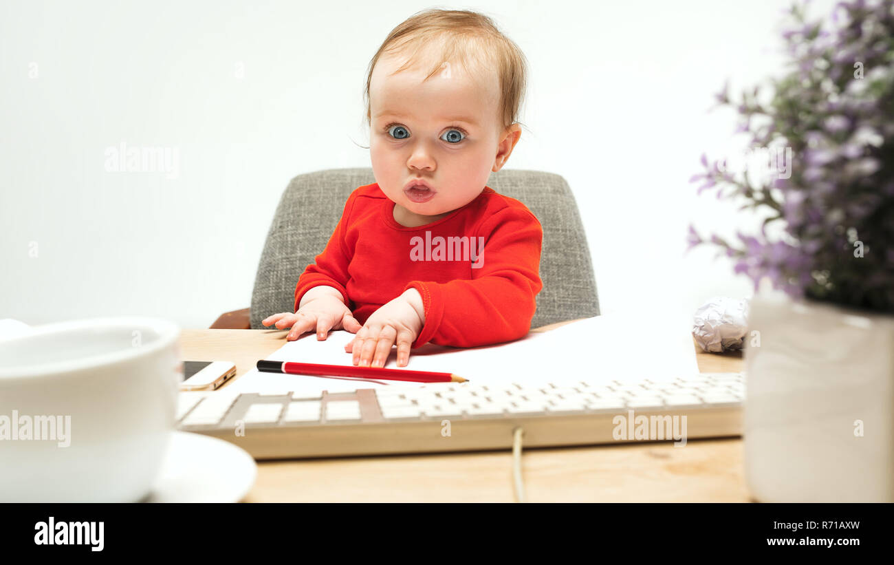 Happy child baby girl toddler sitting with keyboard of computer ...