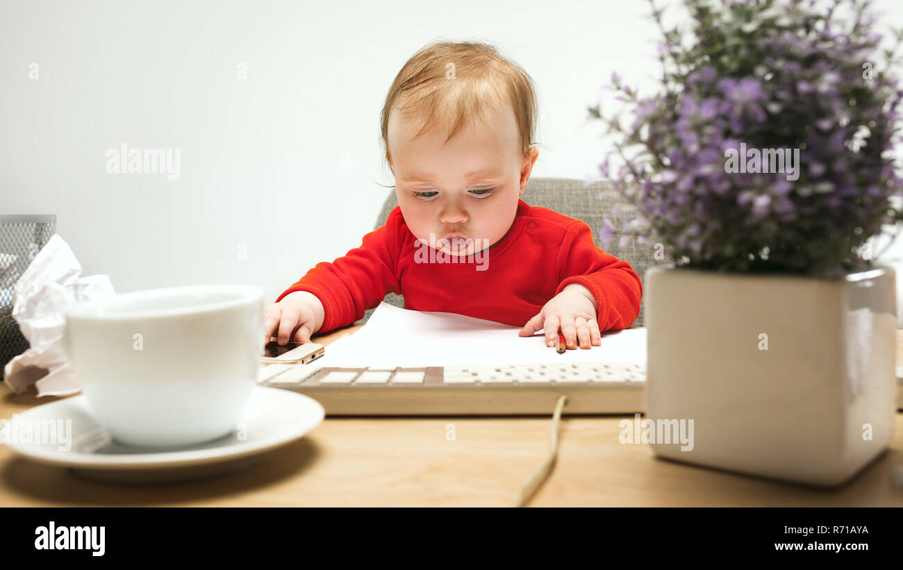 Happy child baby girl toddler sitting with keyboard of computer ...