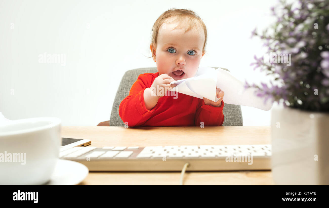 Happy child baby girl toddler sitting with keyboard of computer ...