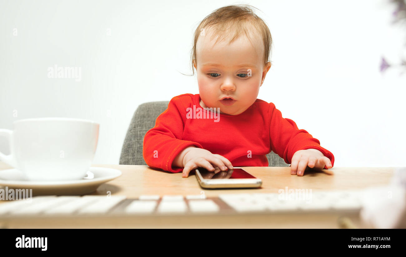Happy child baby girl toddler sitting with keyboard of computer ...