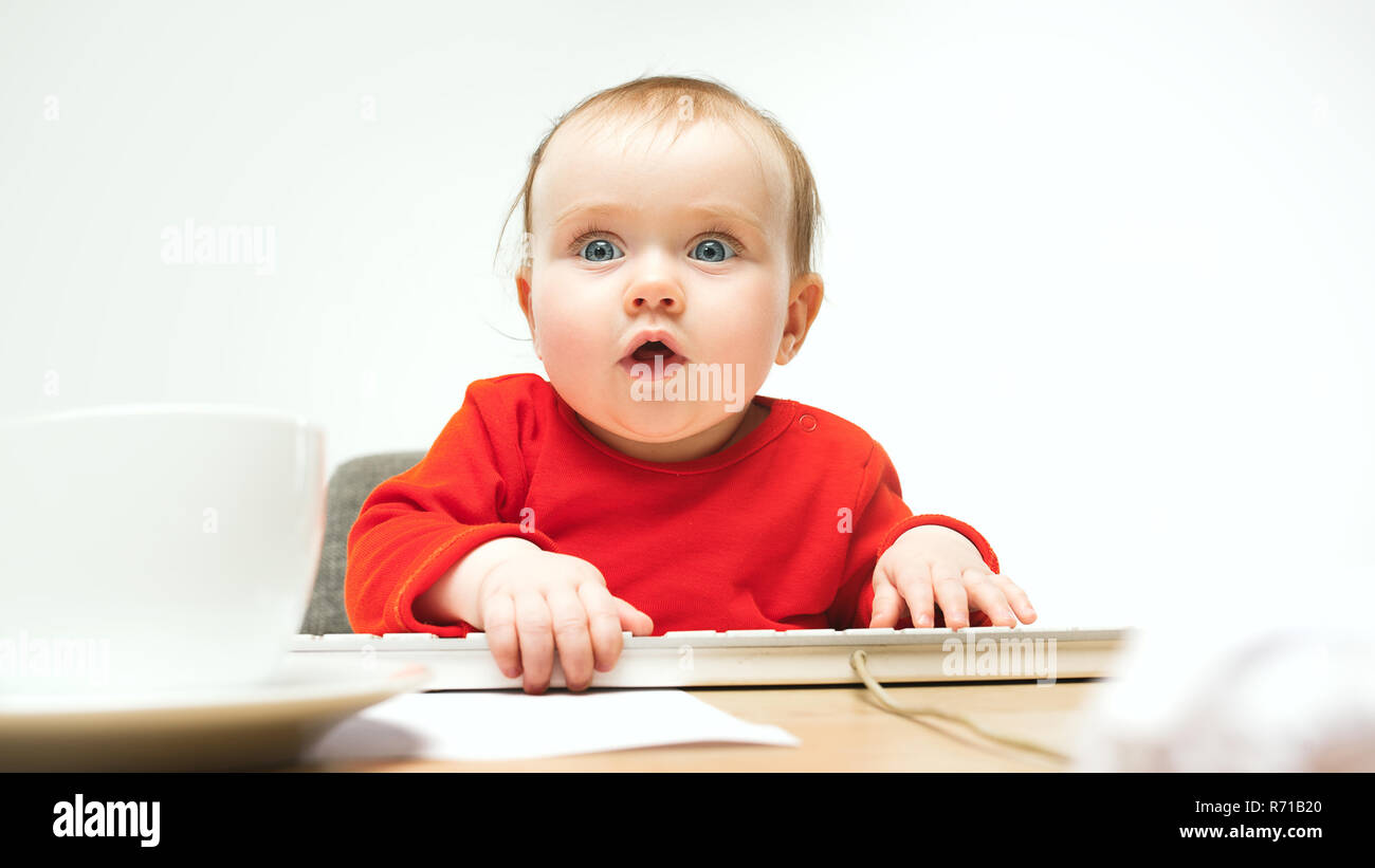 Happy child baby girl toddler sitting with keyboard of computer ...