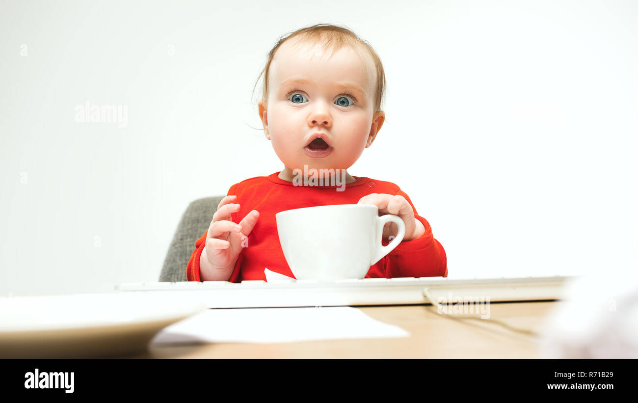 Happy child baby girl toddler sitting with keyboard of computer ...