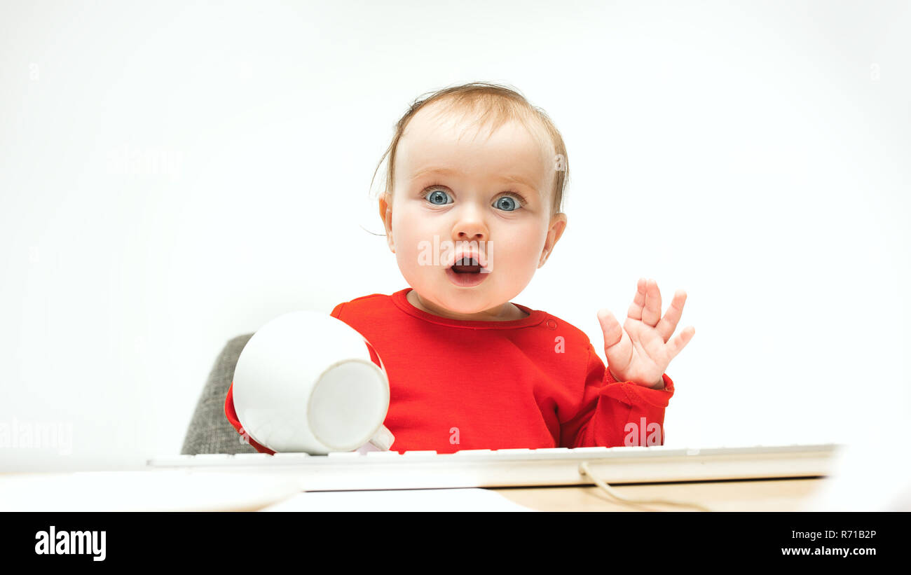 Happy child baby girl toddler sitting with keyboard of computer ...