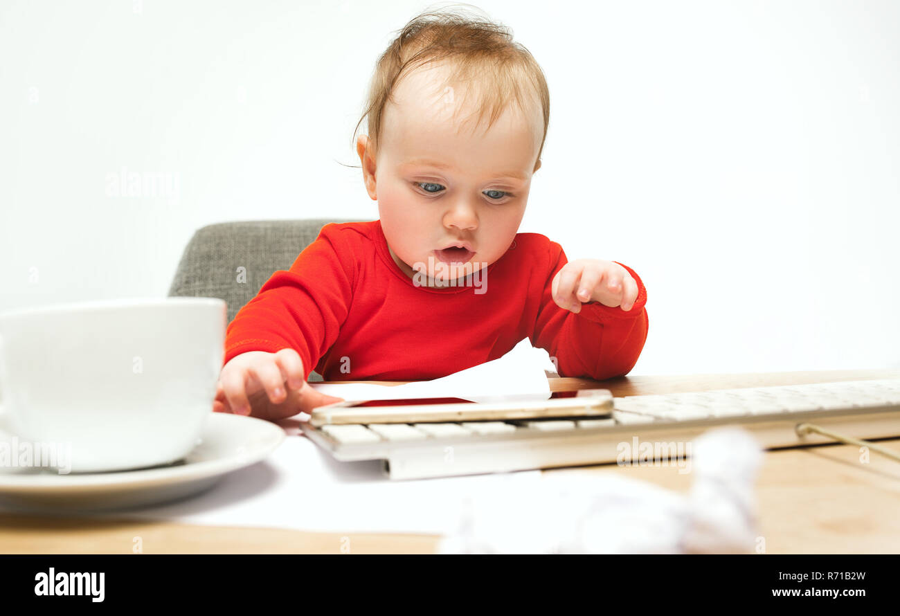 Happy child baby girl toddler sitting with keyboard of computer ...
