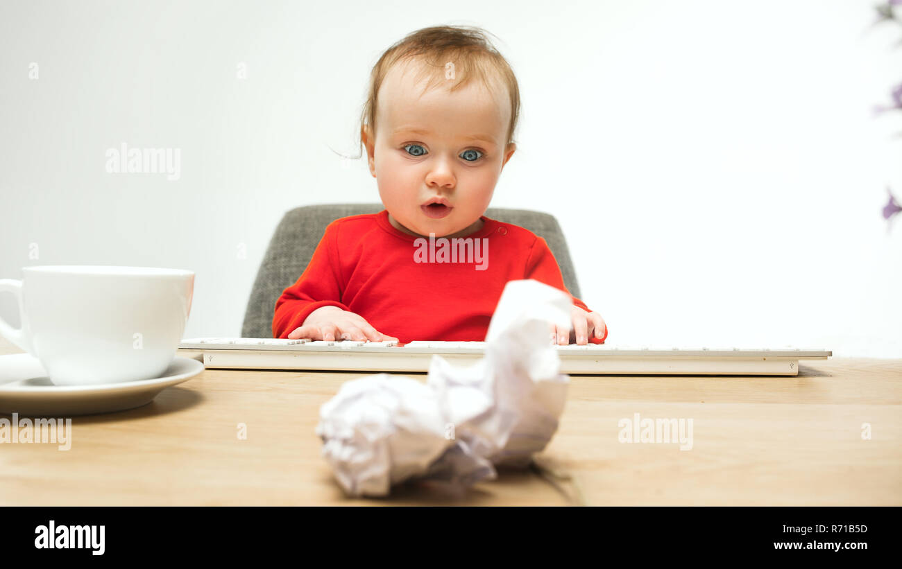 Happy child baby girl toddler sitting with keyboard of computer ...