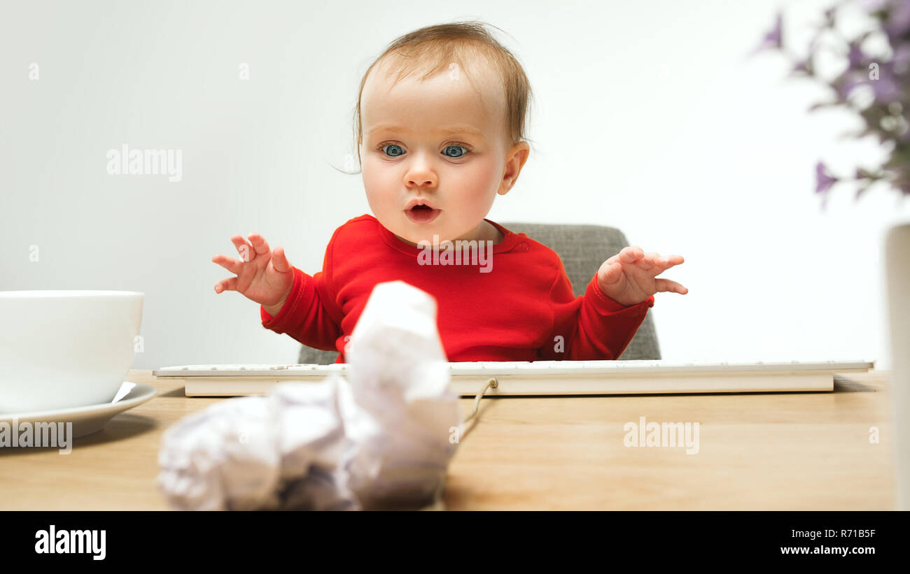 Happy child baby girl toddler sitting with keyboard of computer ...