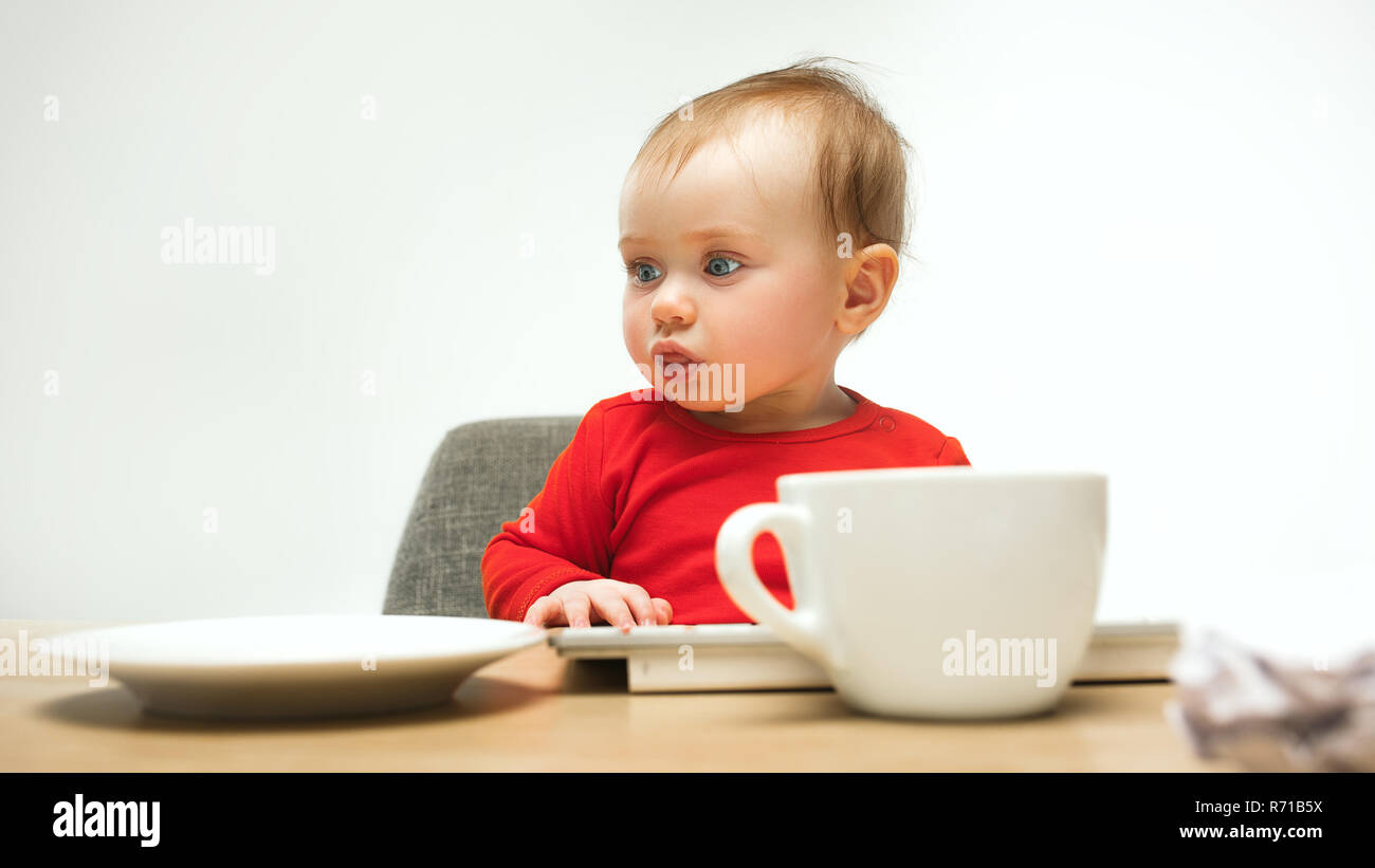Happy child baby girl toddler sitting with keyboard of computer ...