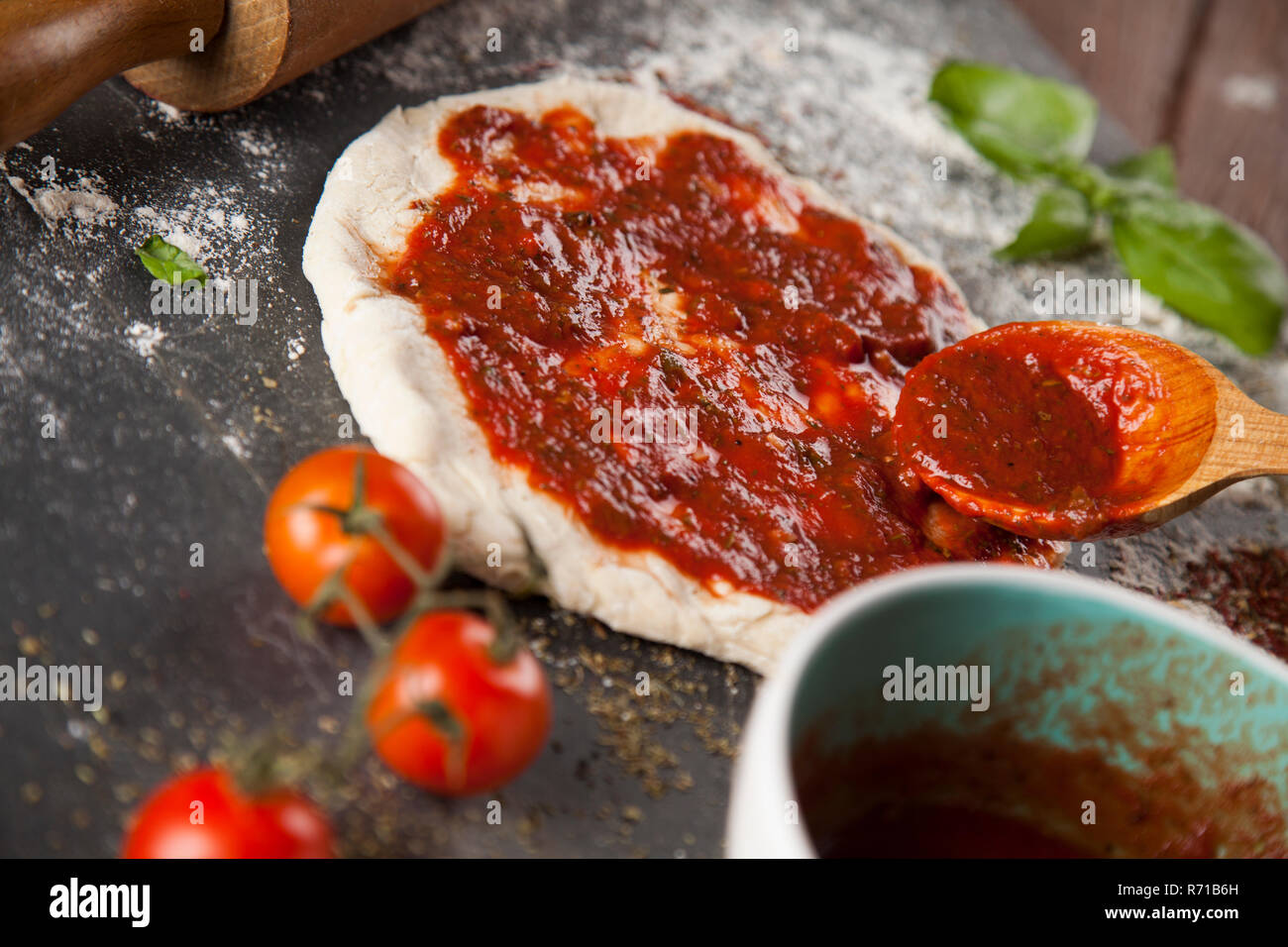 Homemade italian pizza preparation Stock Photo - Alamy
