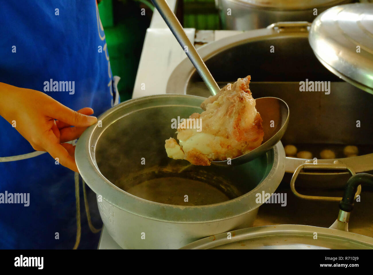 The ladle is drained porksoft in a bowl ,Cooking noodle in thailand,the ...