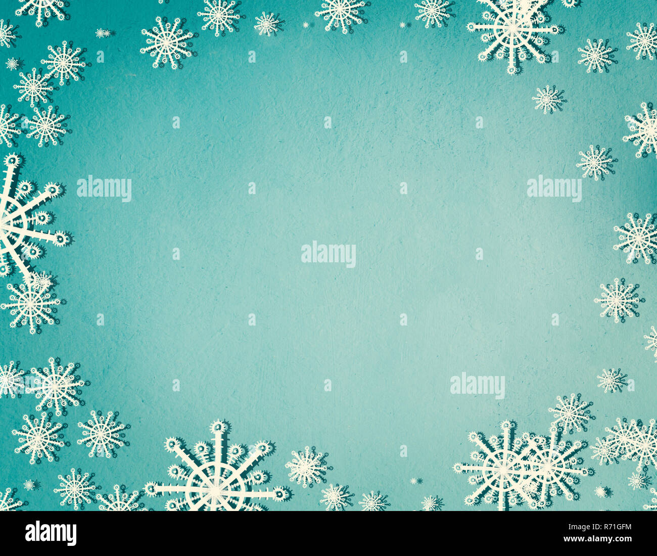 Snowflakes frame on blue turquoise background with copy space, top view ...