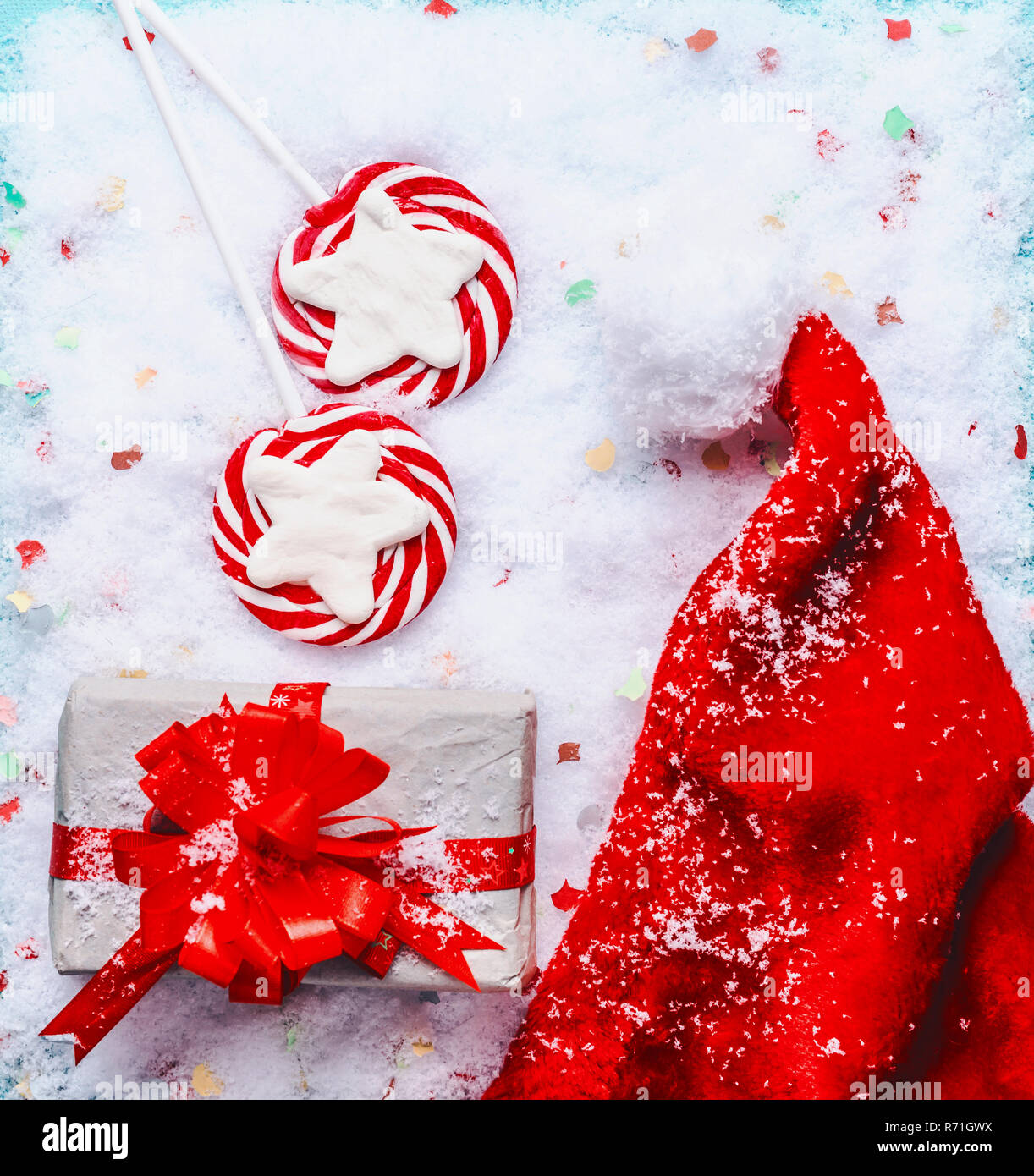 Christmas concept. Santa hat with Christmas gift box and red candy ...