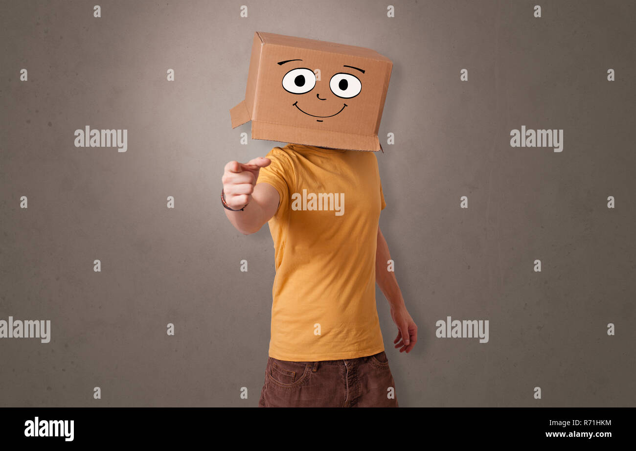 Young boy standing and gesturing with a cardboard box on his head Stock ...