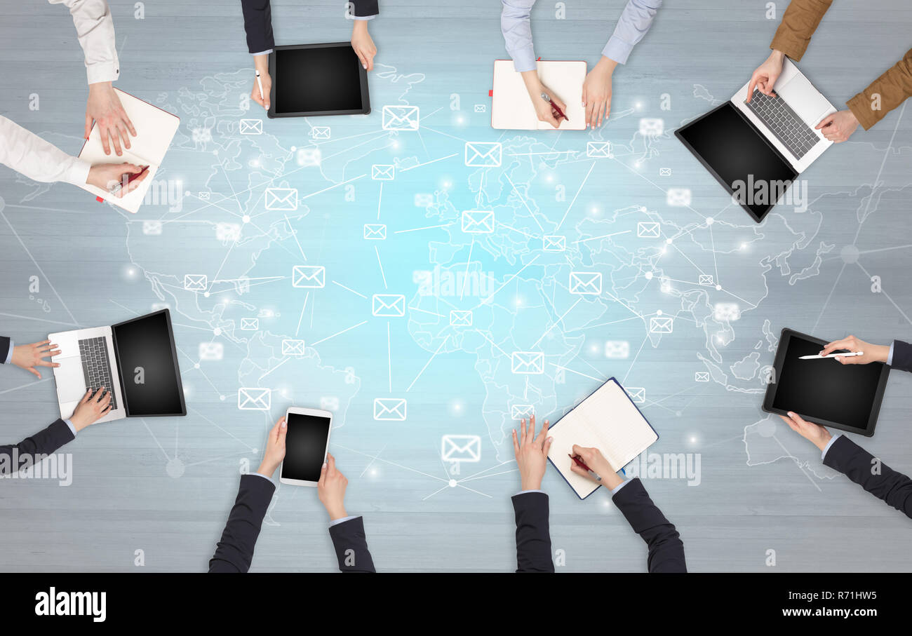 Group of people with devices in hands working in team on tablets ...