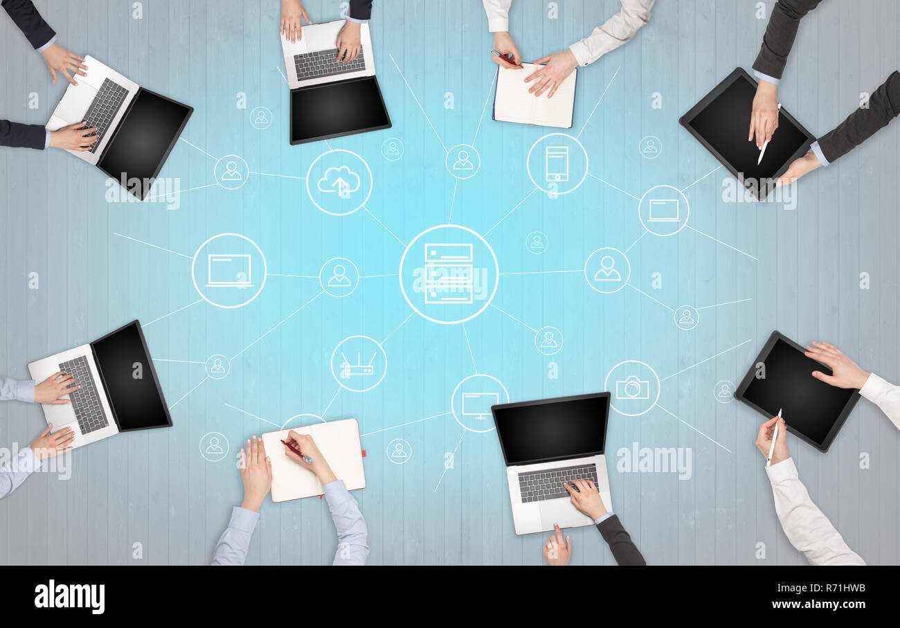 Group of people with devices in hands working in team on tablets ...