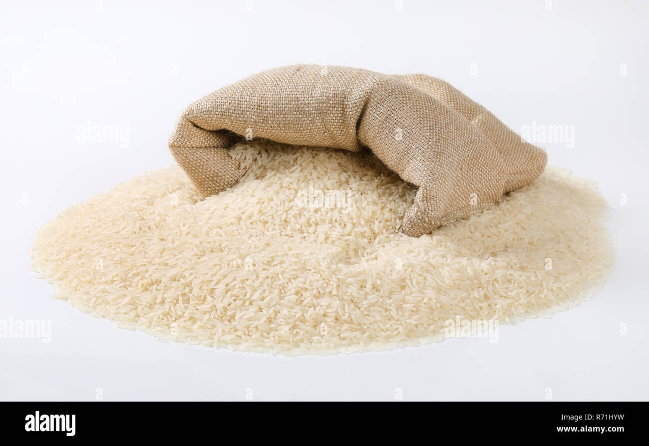 bag and pile of white long grained rice Stock Photo - Alamy