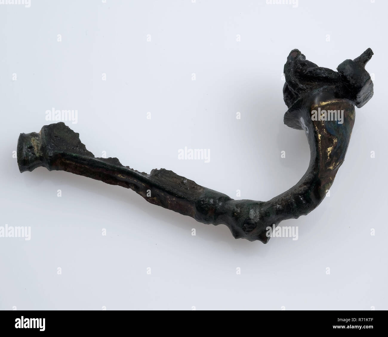 Bronze fibula or mantle pin decorated with enamel, part of the needle ...