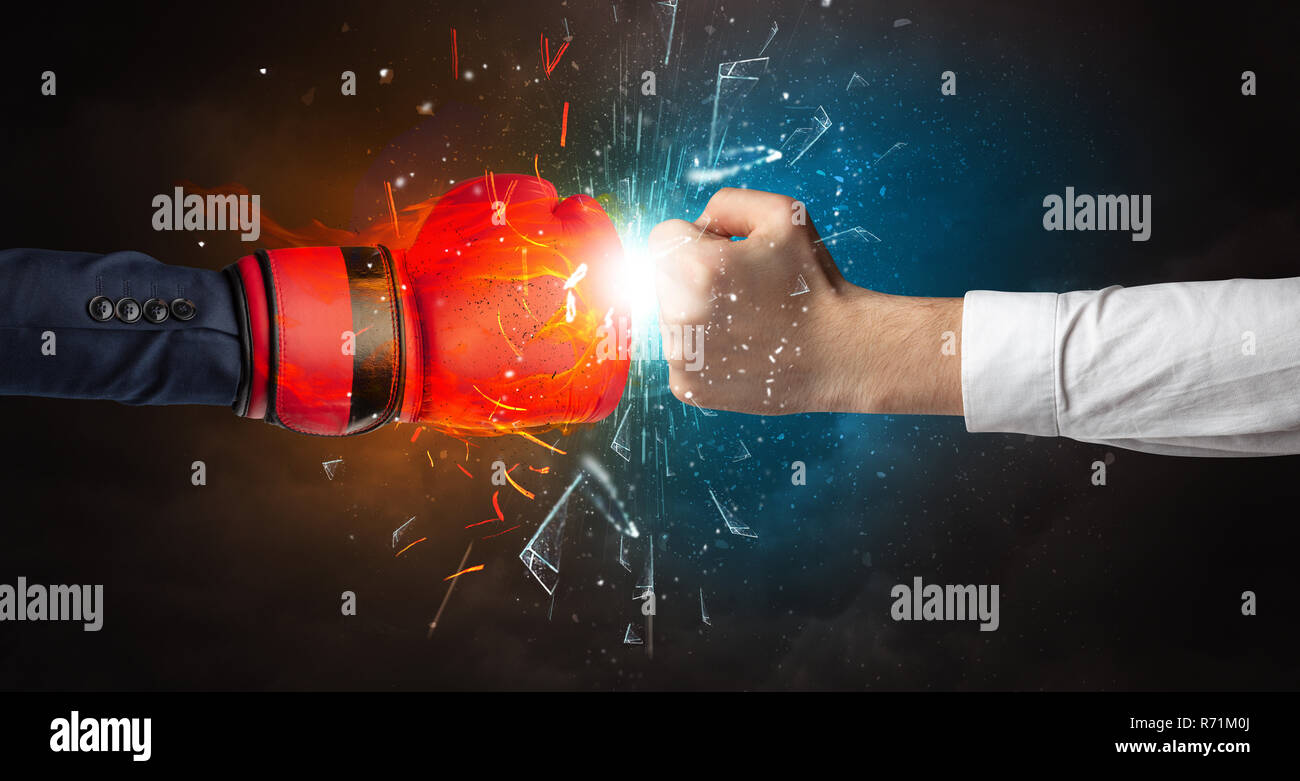 Two hands fighting and breaking glass into small pieces with fire and ...