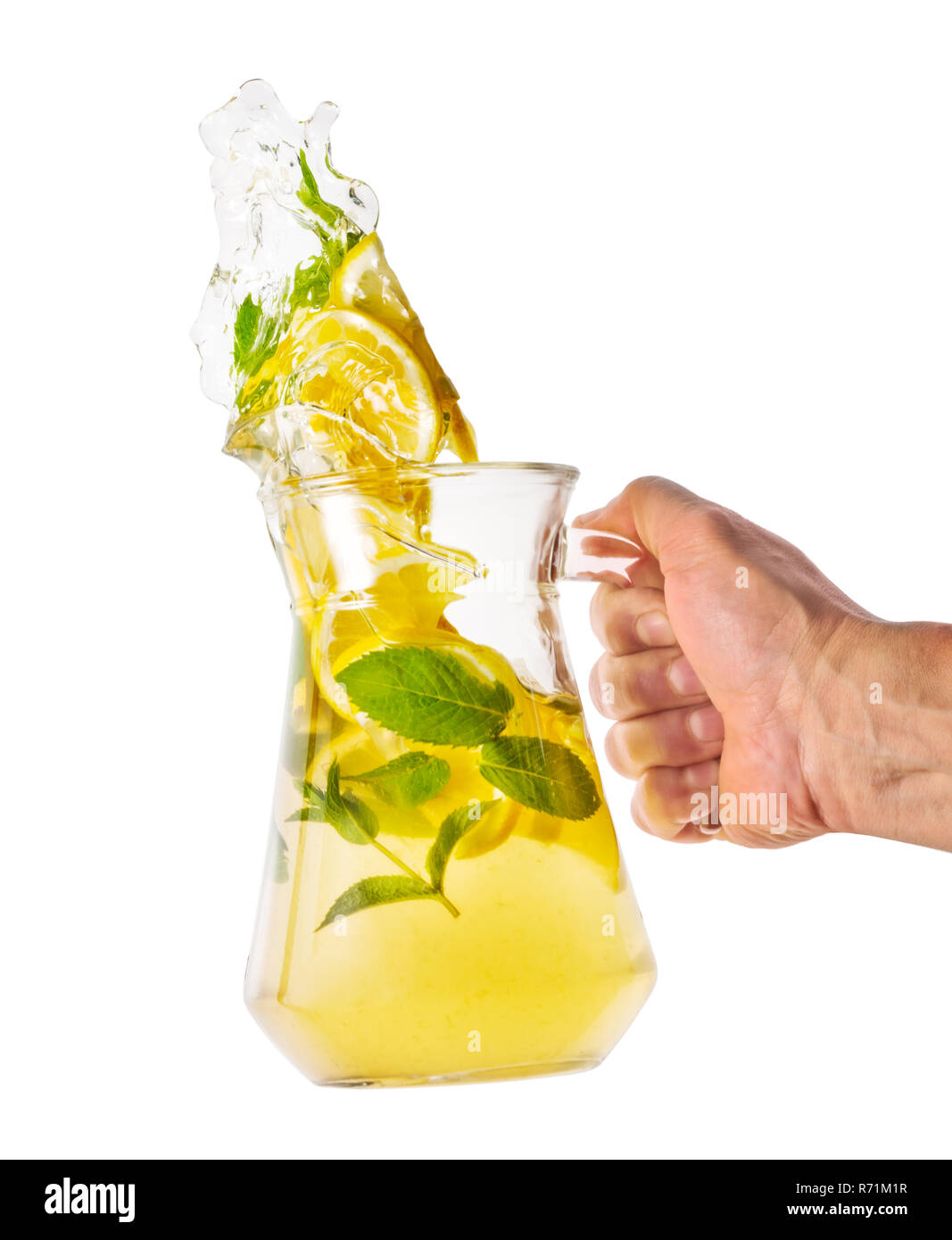 Hand with a jug with spilling homemade lemonade isolated on white ...