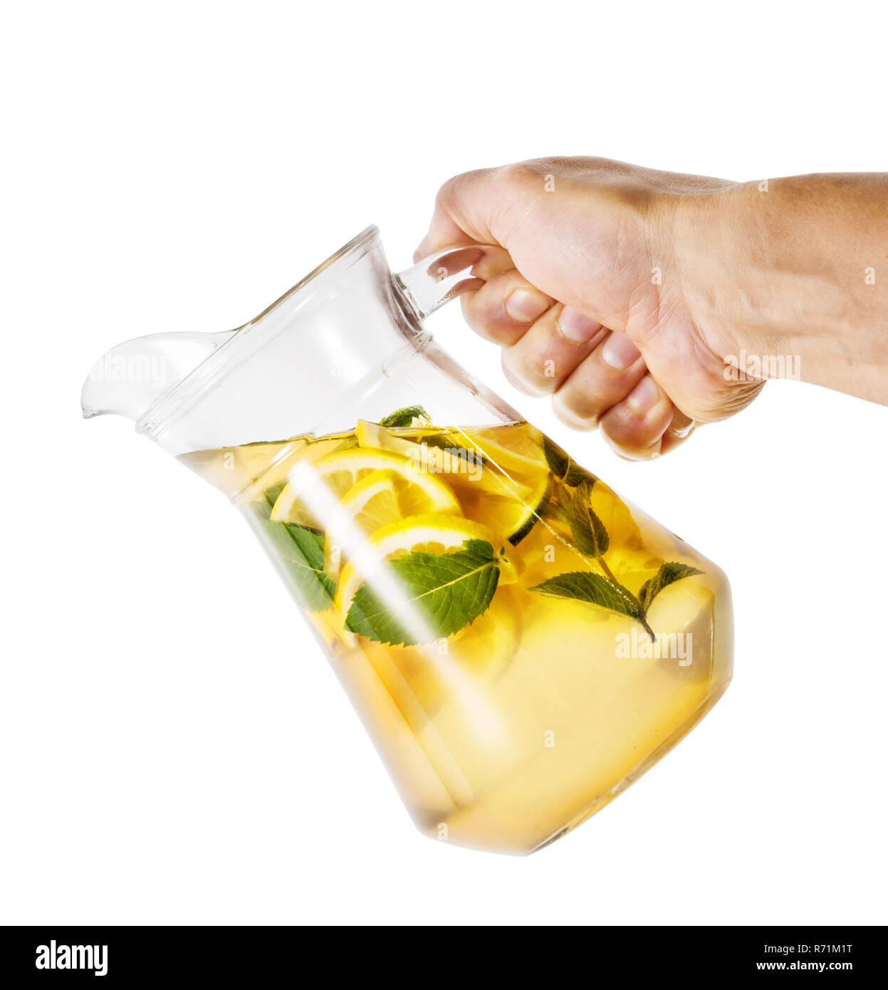 Hand with tilted jug of homemade lemonade isolated on white background ...