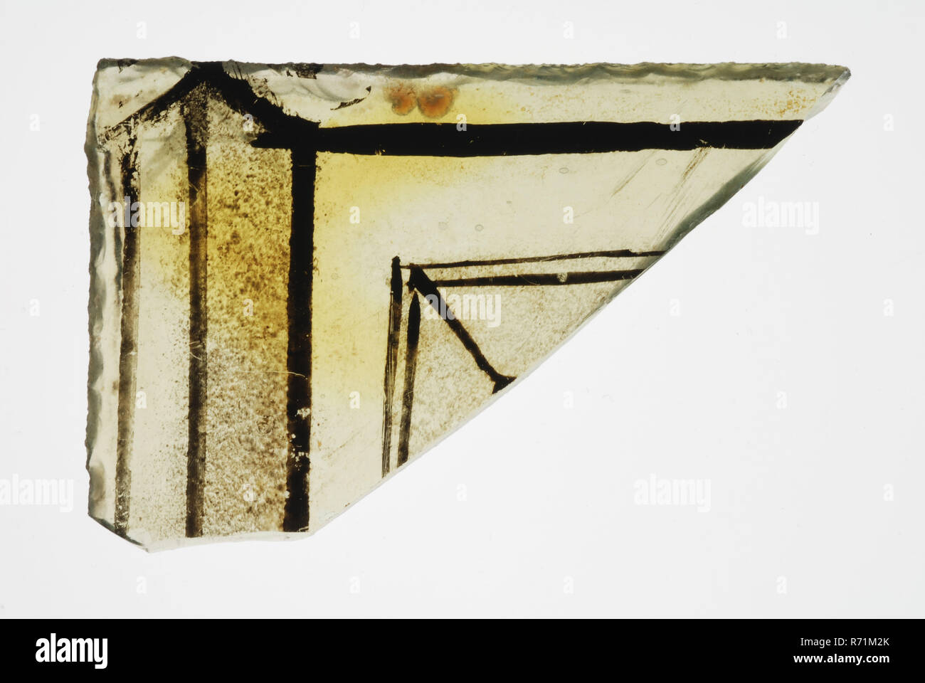 Corner fragment of green window glass with stained-glass decor, plinth ...