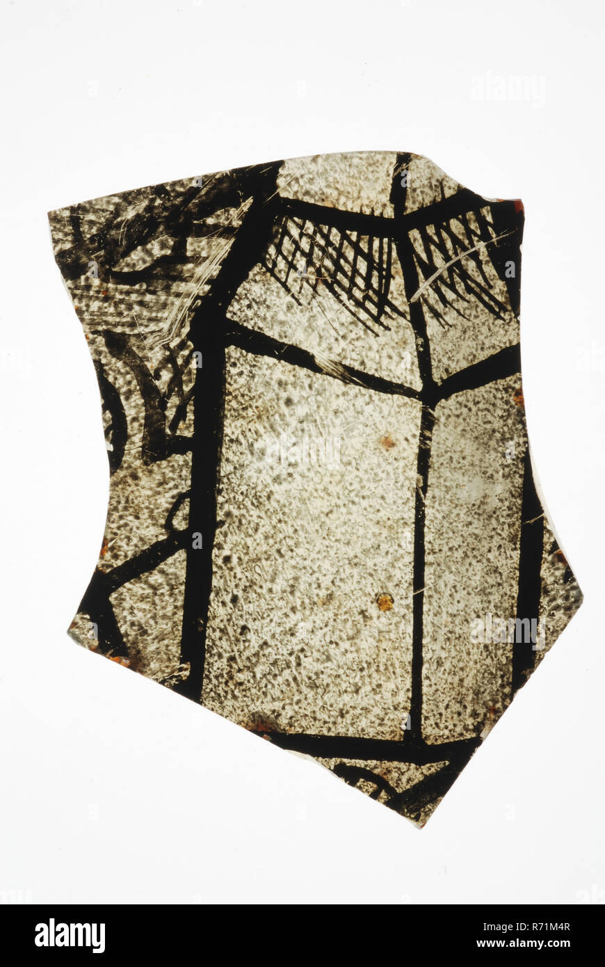 Fragment of green window glass with stained-glass decoration, plinth or ...