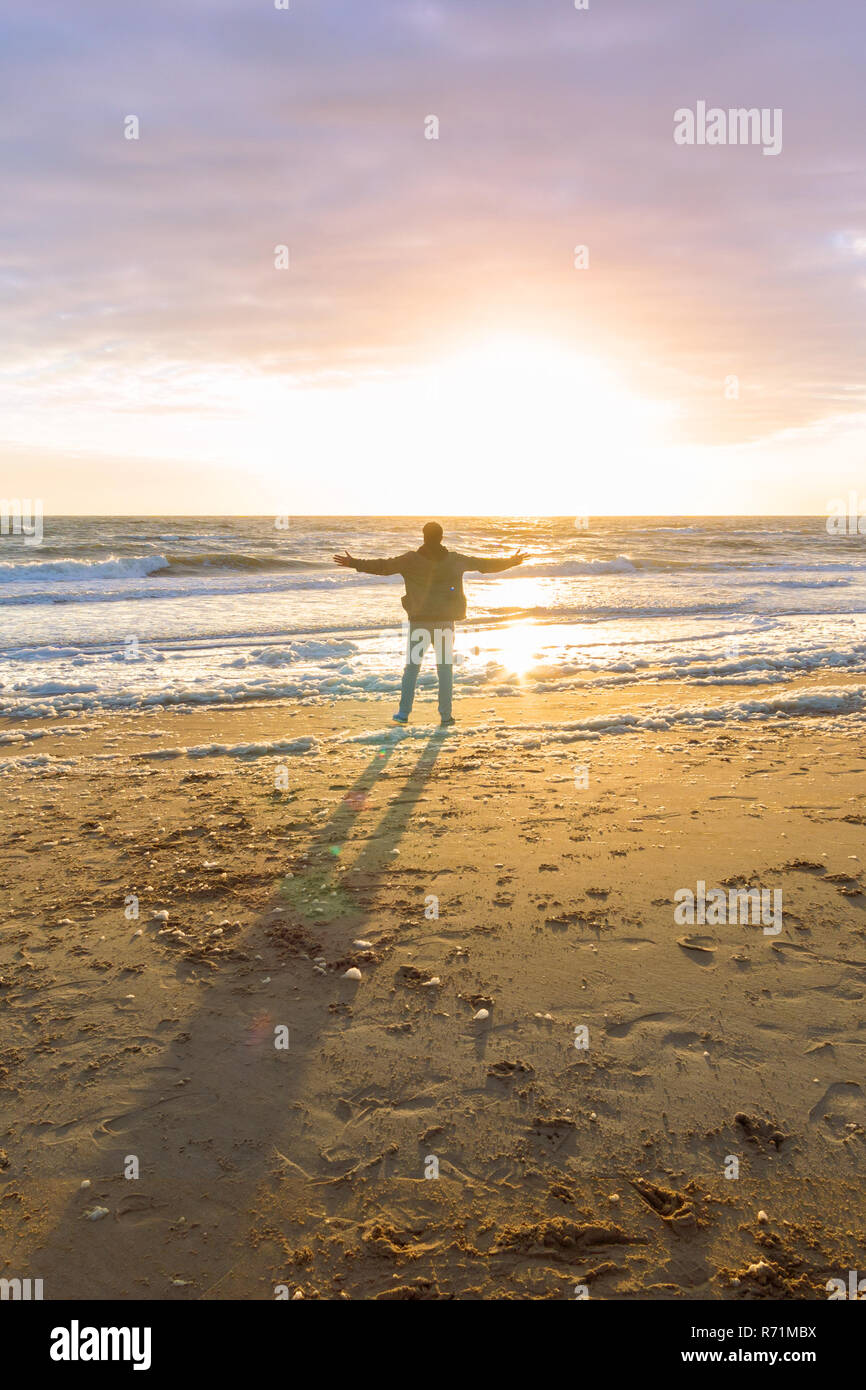 Man rising his arms at the beach at the sea Stock Photo - Alamy