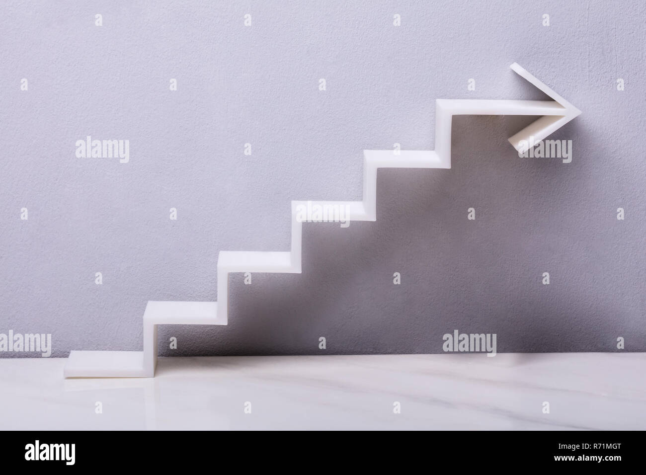 White Arrow Of Growth On Wall Stock Photo - Alamy