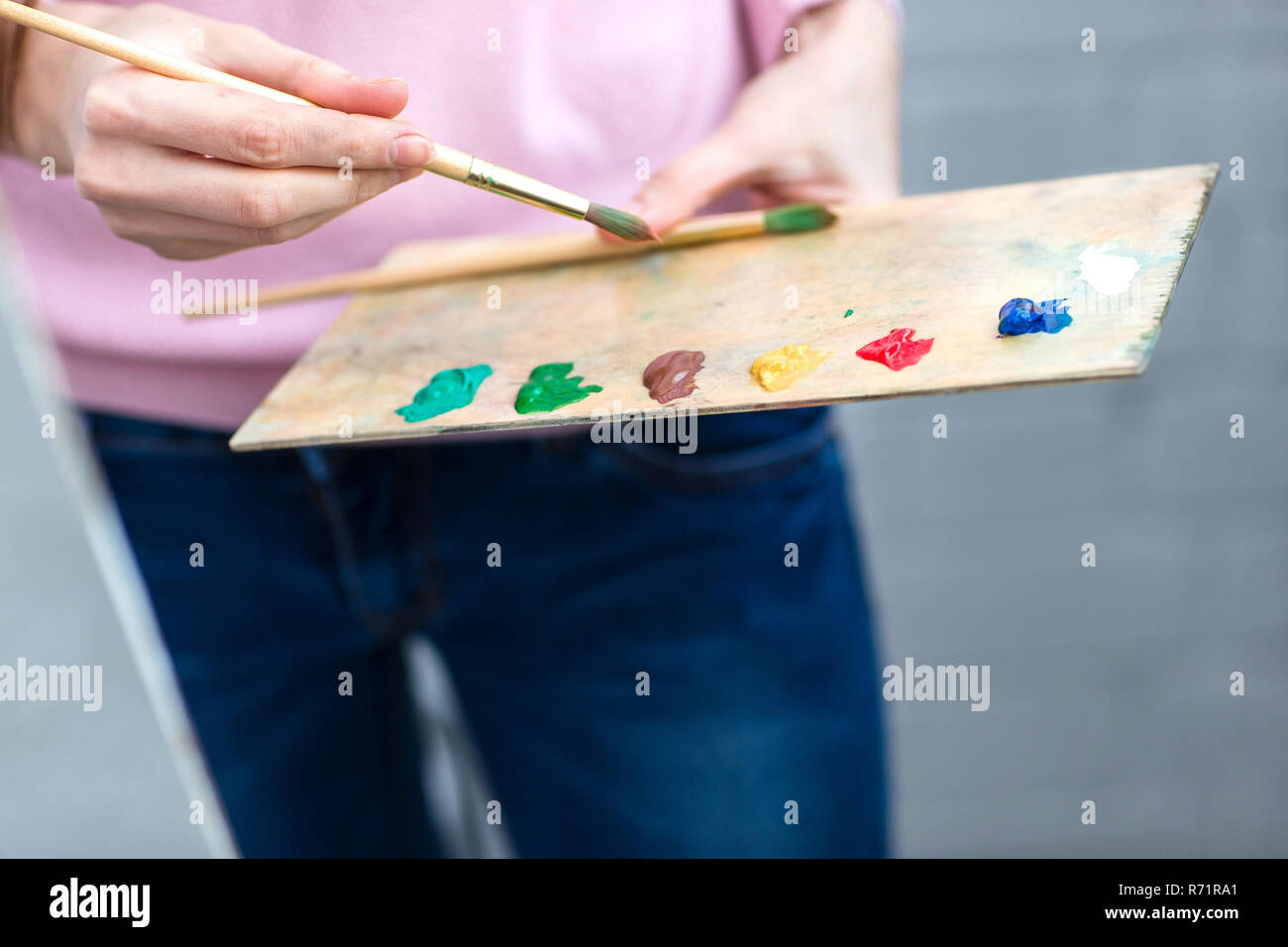 The palette of colors in the hands of a girl Stock Photo - Alamy