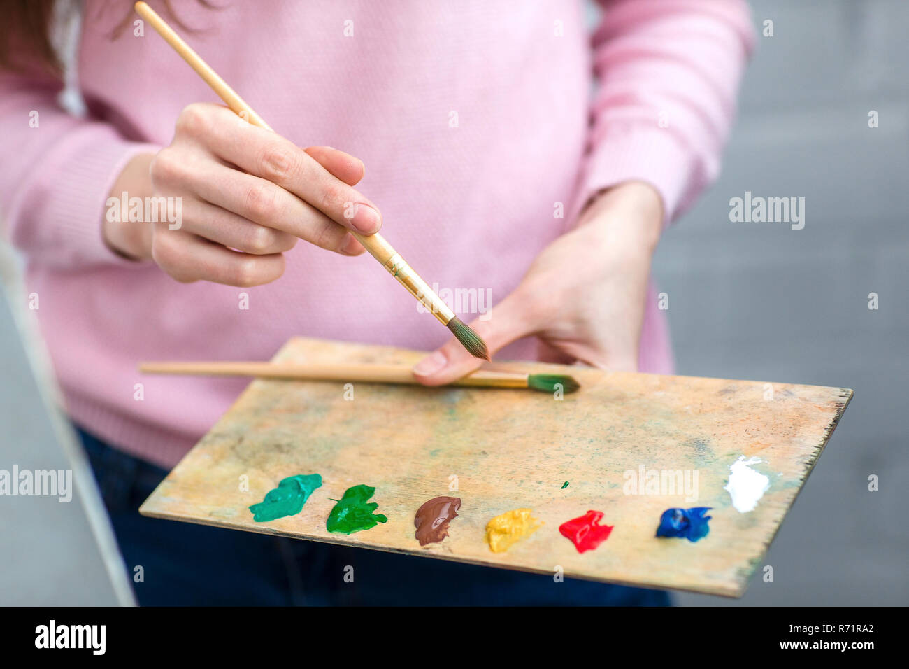 The palette of colors in the hands of a girl Stock Photo - Alamy