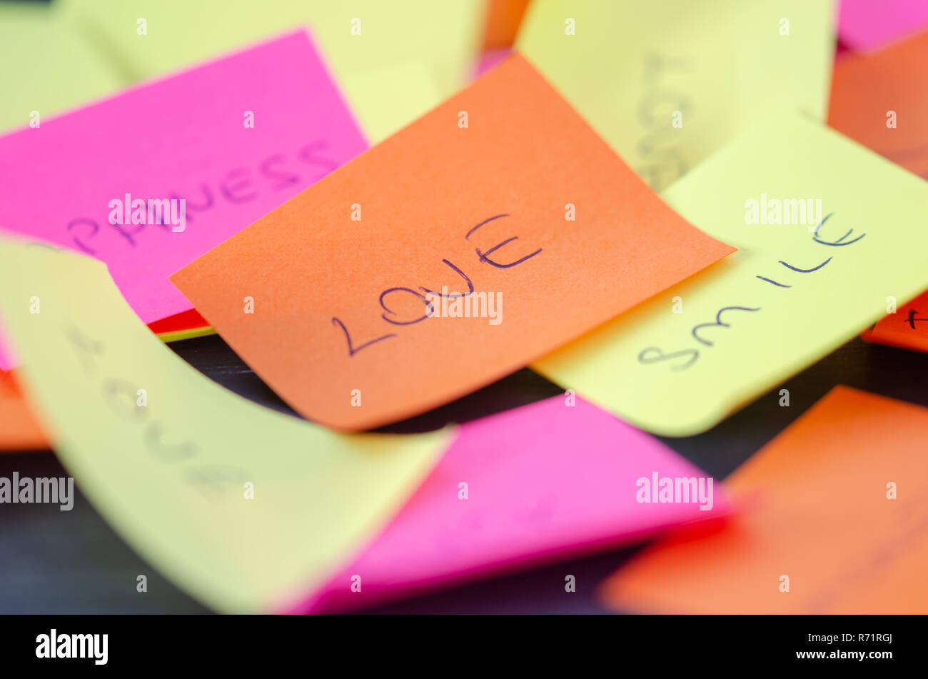 Good wishes are written on colorful note paper. Blurred background ...