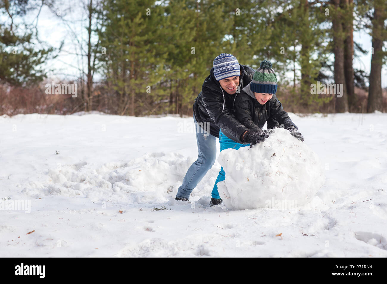 Happy dad with his son playing in the winter snow park Stock Photo - Alamy