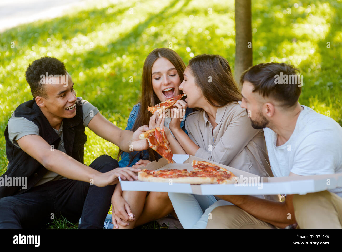 College mates are eating pizza Stock Photo - Alamy