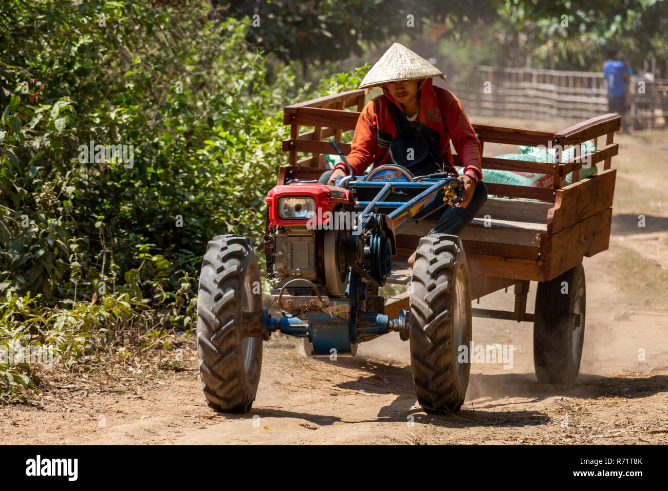 Don Daeng, Laos - April 27, 2018: Young boy driving a tractor in a ...