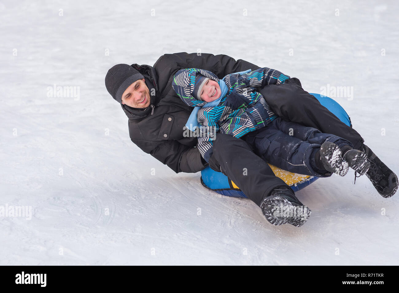 A young man with a cheerful boy with a roller coaster ride in the ...