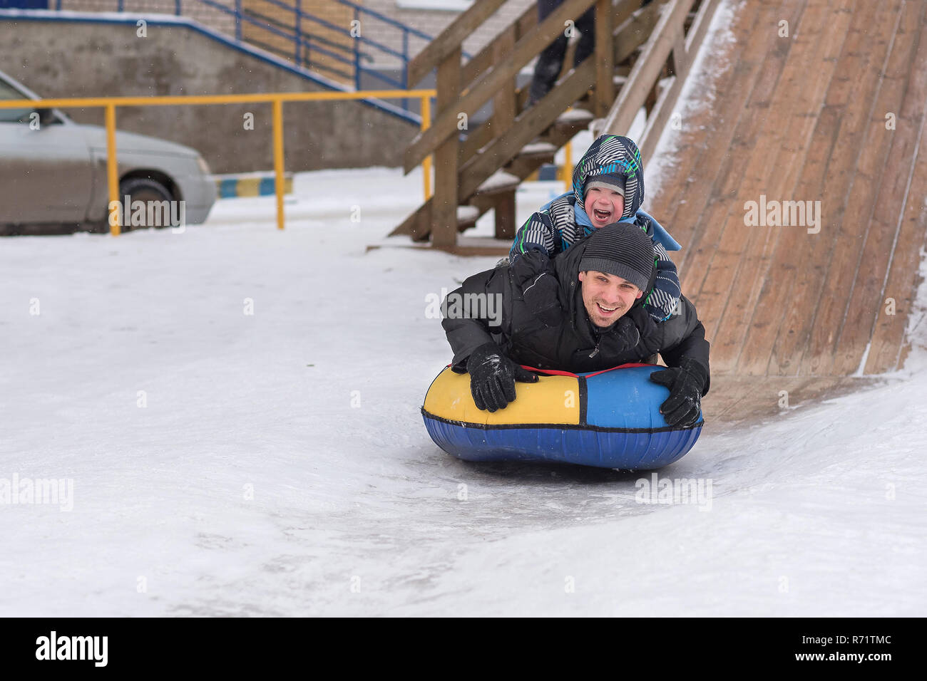 A young man with a cheerful boy with a roller coaster ride in the ...