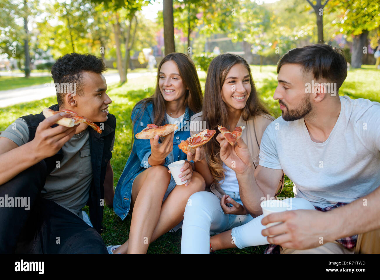 Friends having a pizza party Stock Photo - Alamy