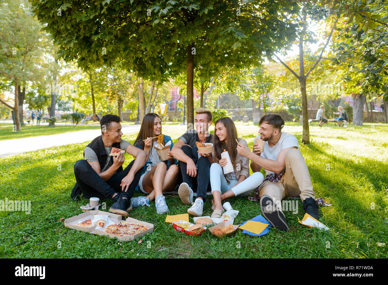 Friends are enjoying street food Stock Photo - Alamy