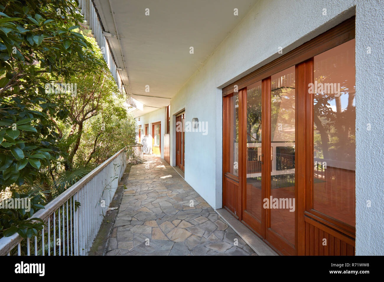 Large terrace with plants and room interior in country house, sunlight ...